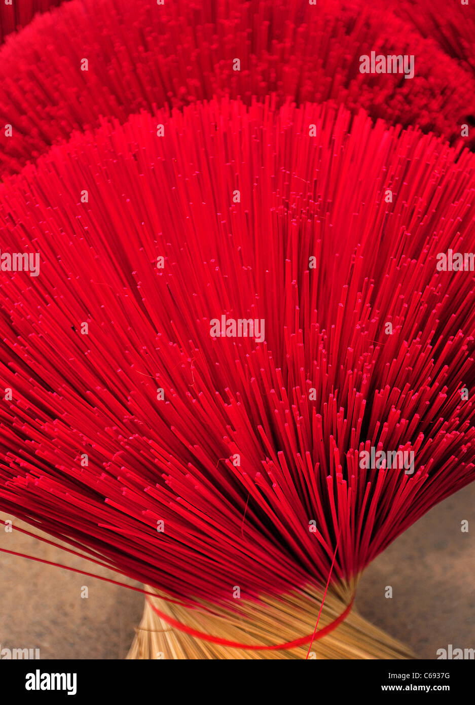 Bundles of fragrant red incense on display Stock Photo - Alamy