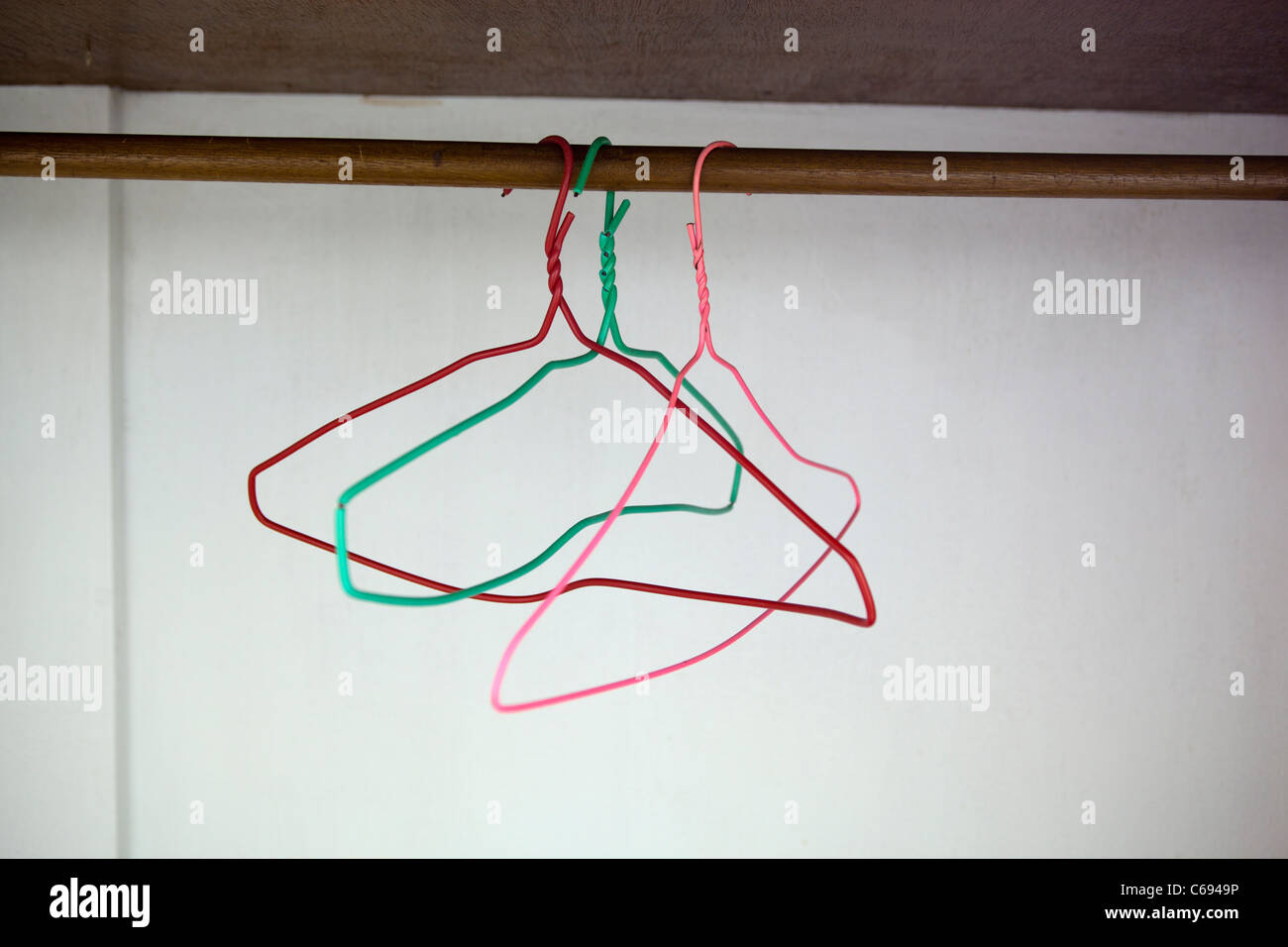 wire coat hangers hanging in wardrobe Stock Photo - Alamy