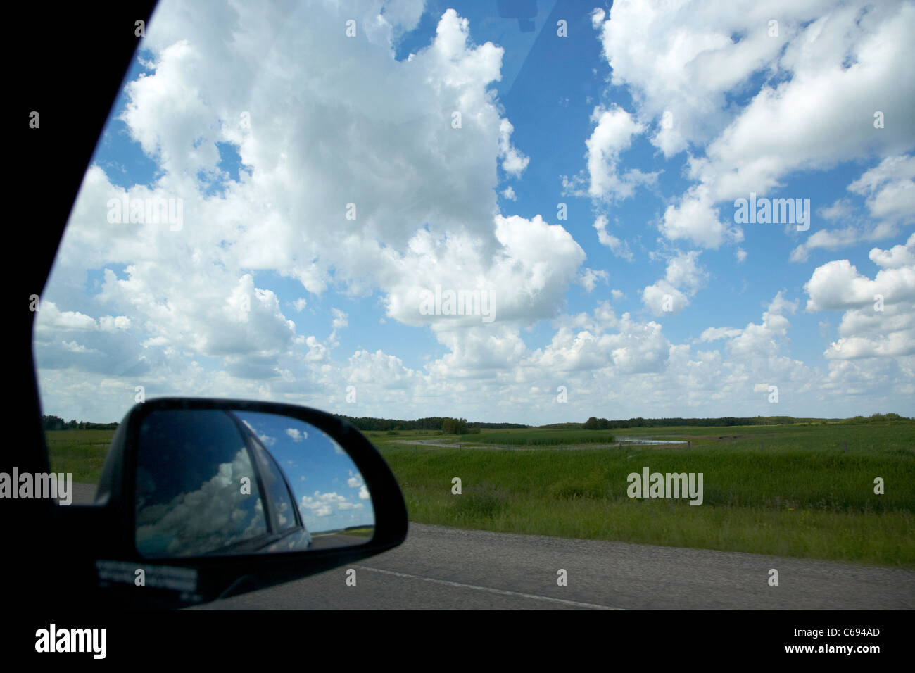 looking out window at cloudy sky on yellowhead highway route 16 through ...