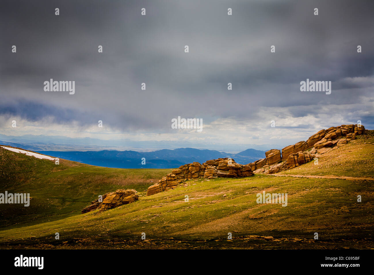 Landscape with rain clouds forming over a valley Stock Photo - Alamy