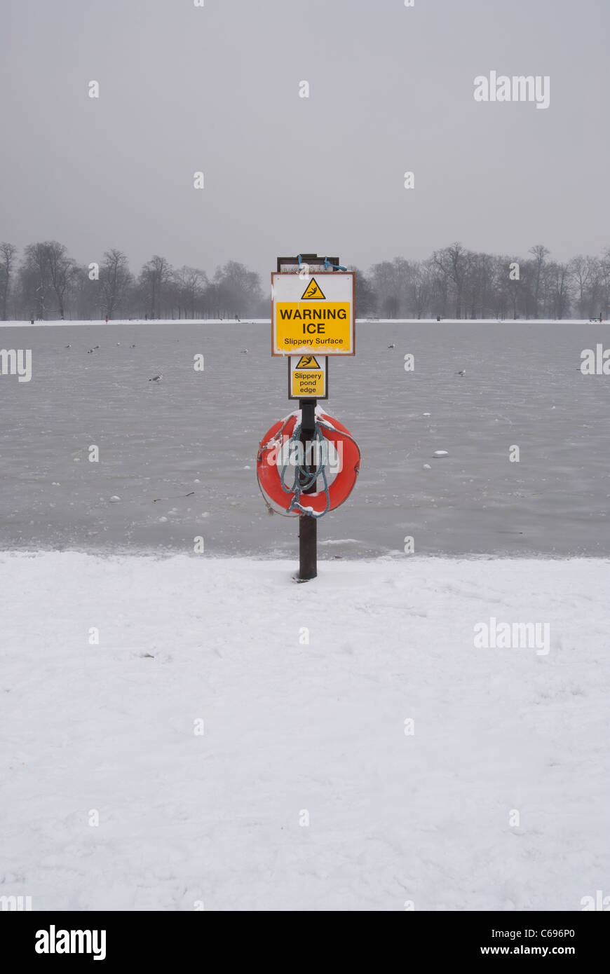warning ice sign at the round pond in London's Hyde Park after snow ...