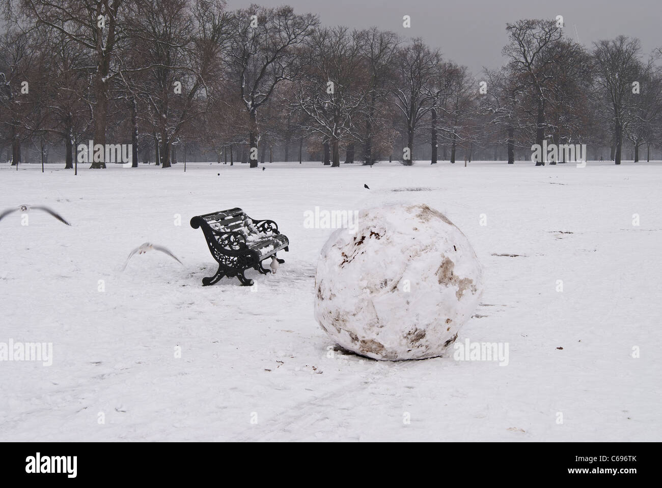 Giant snowball beside a park bench in London's Hyde Park in winter ...