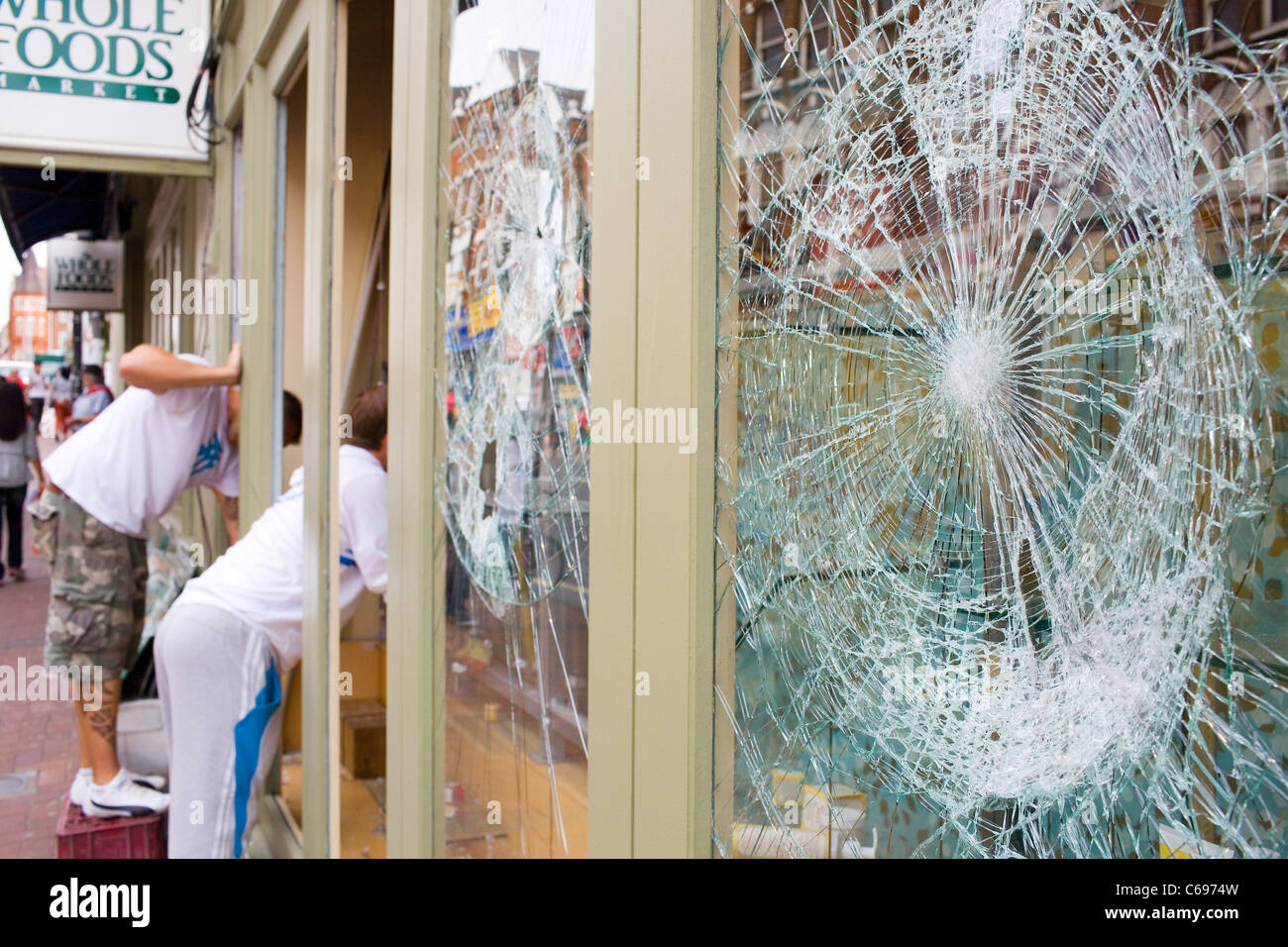 Smashed glass during the London riots is replaced in Clapham, London ...