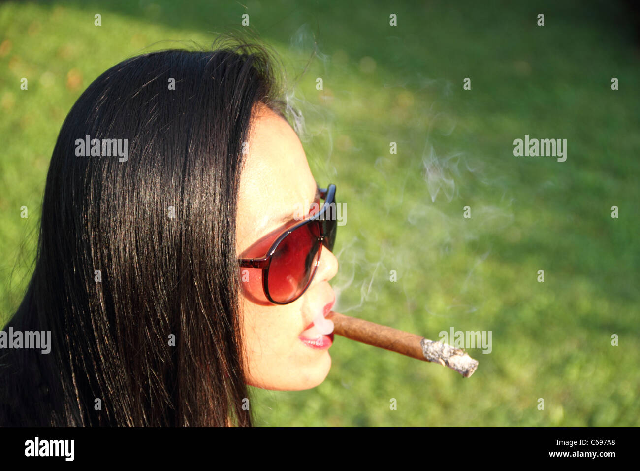lady, enjoy a good cigar at a sunny day Stock Photo - Alamy