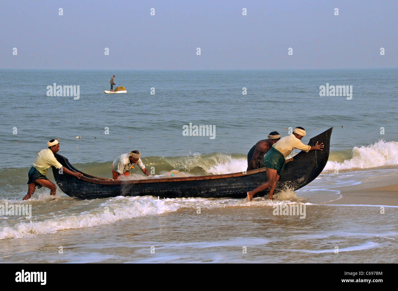 Fishermen beaching fishing boat Marari Beach Kerala South India Stock ...