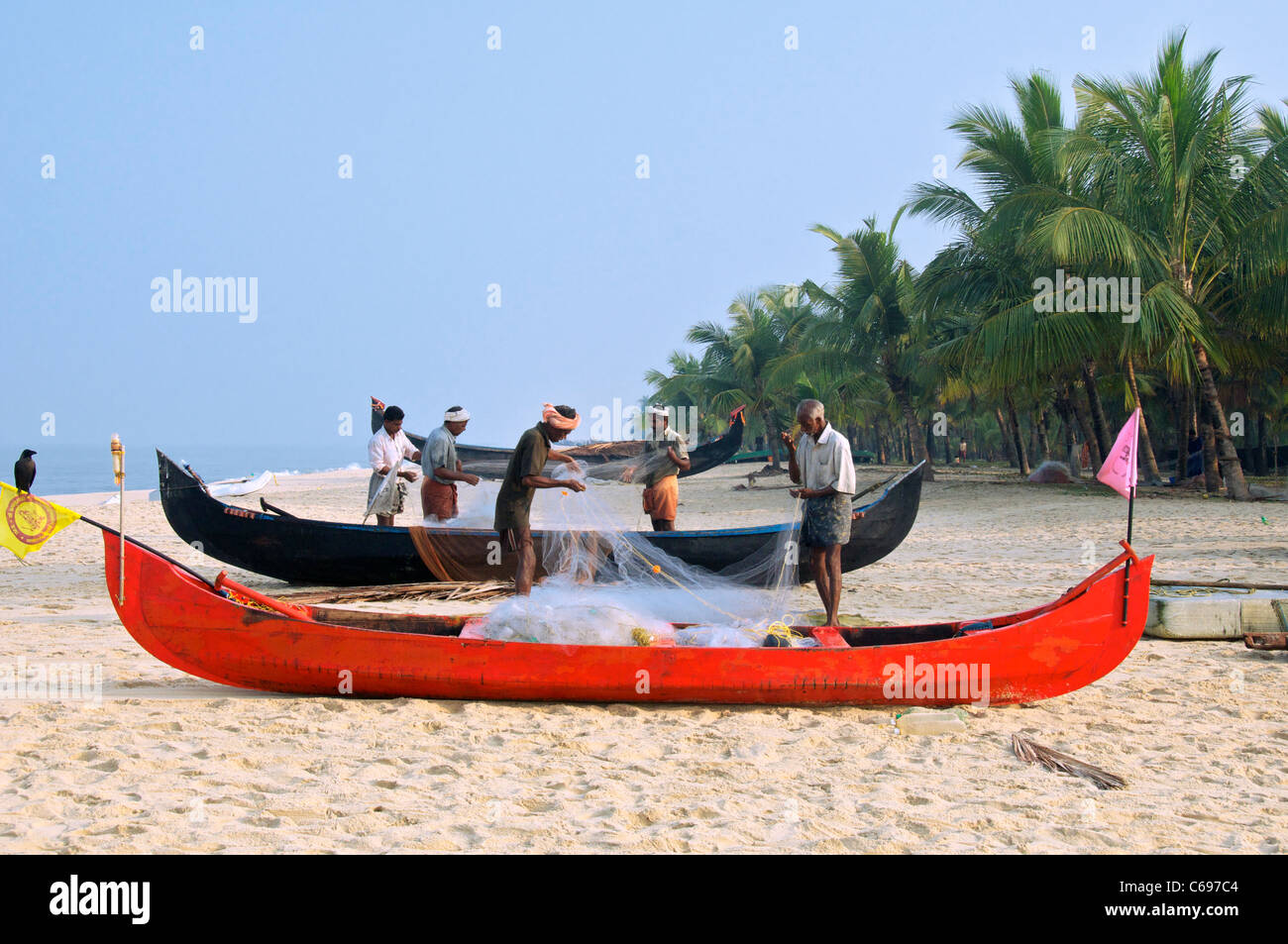 Fishermen sorting fishing nets on Marari Beach Kerala South India Stock ...