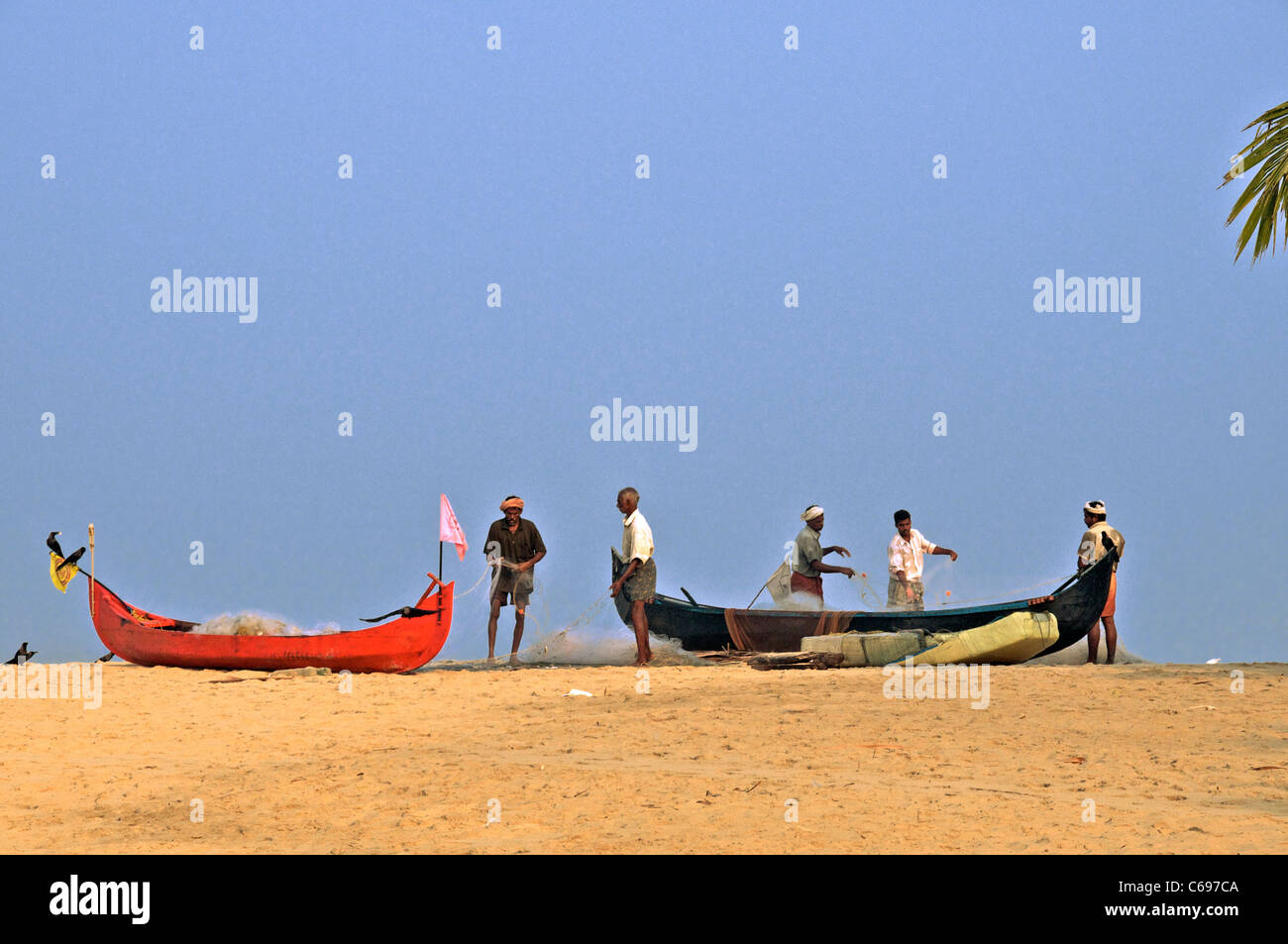 Fishermen sorting fishing nets on Marari Beach Kerala South India Stock ...