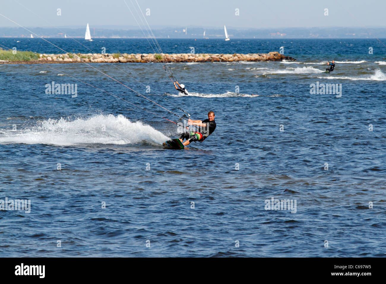 Kitesurfers at Nivå Bay near Nivå Marina on a windy summer day. The ...