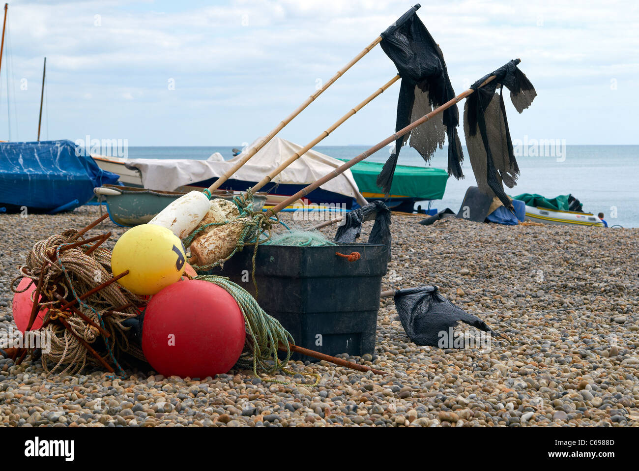 The beach at Beer, Devon, England with fishing boats, crab pots and ...