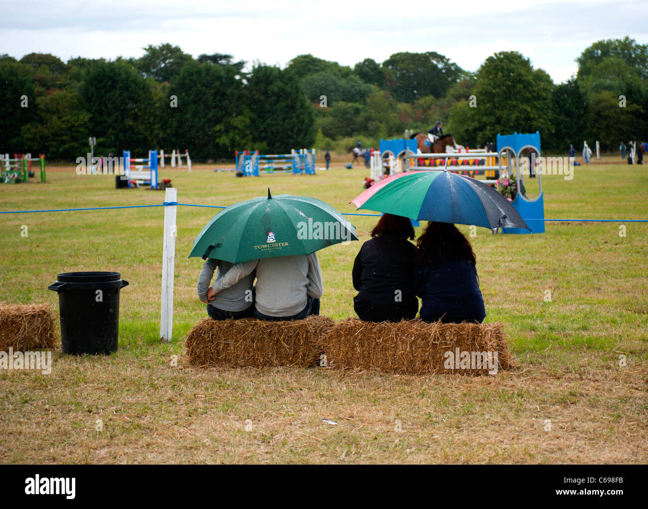 People at an outside event in typical English rainy weather, with ...