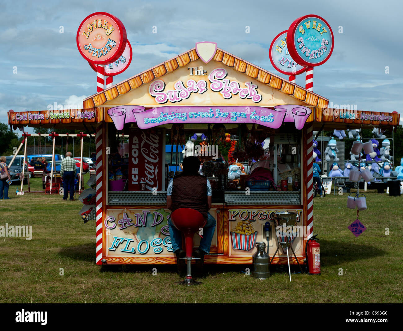 Man sat at a candy floss and pop corn stall at a country fair Stock ...