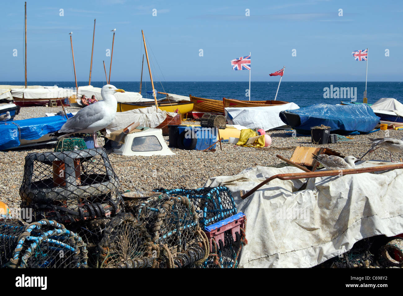 The beach at Beer, Devon, England with fishing boats, crab pots and ...