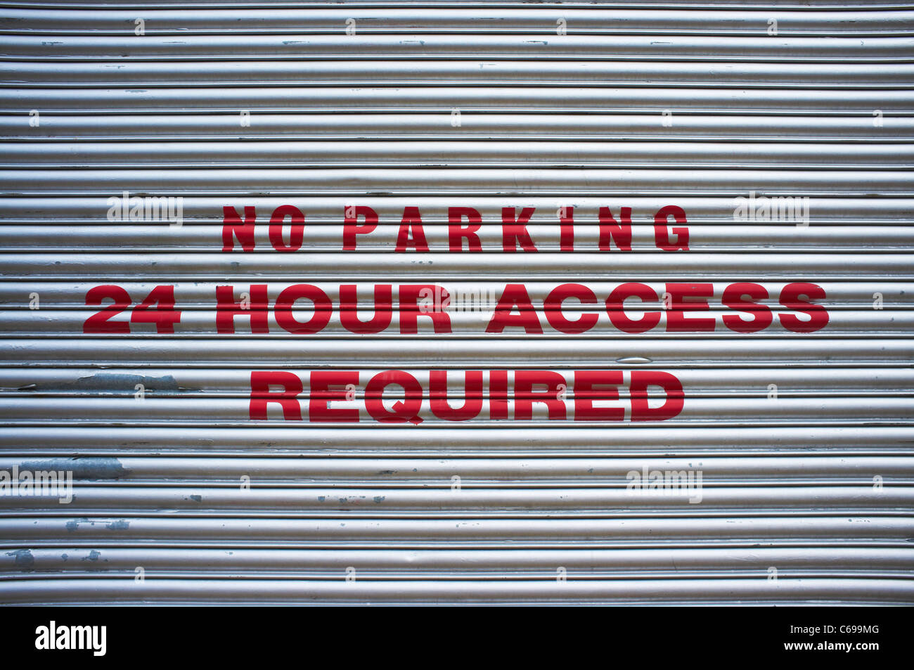 No Parking 24 Access Required sign painted on a shuttered garage door ...