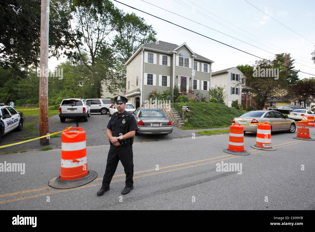 Policeman outside suburban house crime scene, Billerica, Massachusetts ...