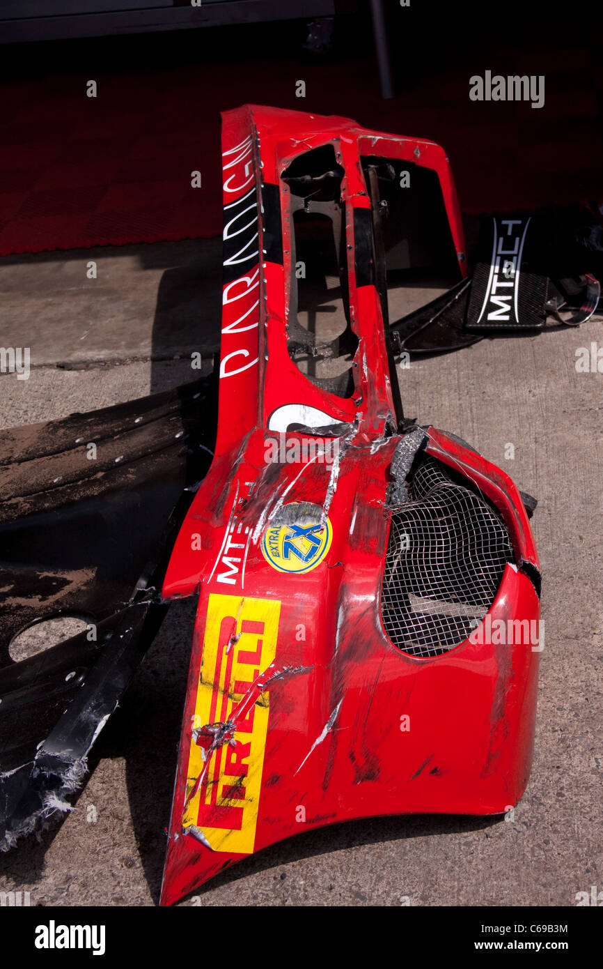 Damaged Ferrari GT rear bumper on floor of pit garage at Oulten Park ...