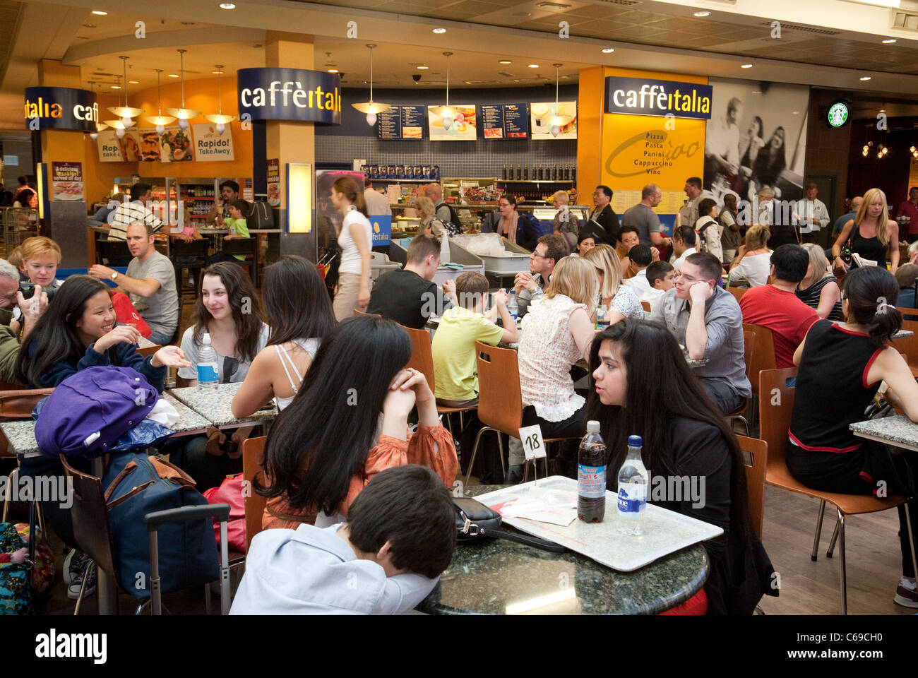 Air passengers eating at the caffe Italia cafe , terminal 3, Heathrow ...