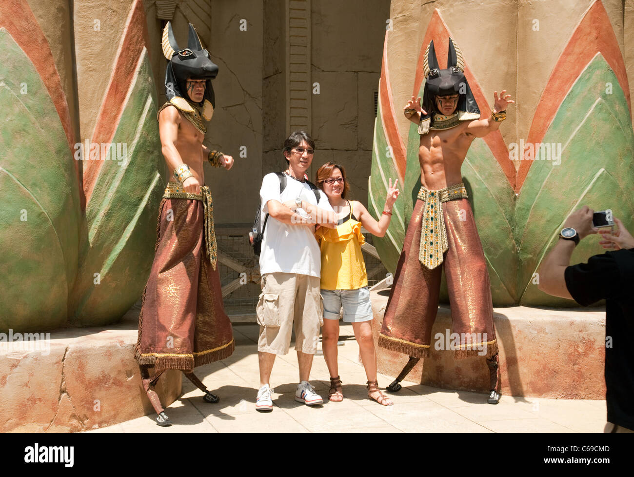 Tourists pose with costumed models in "The Mummy" area, Universal ...