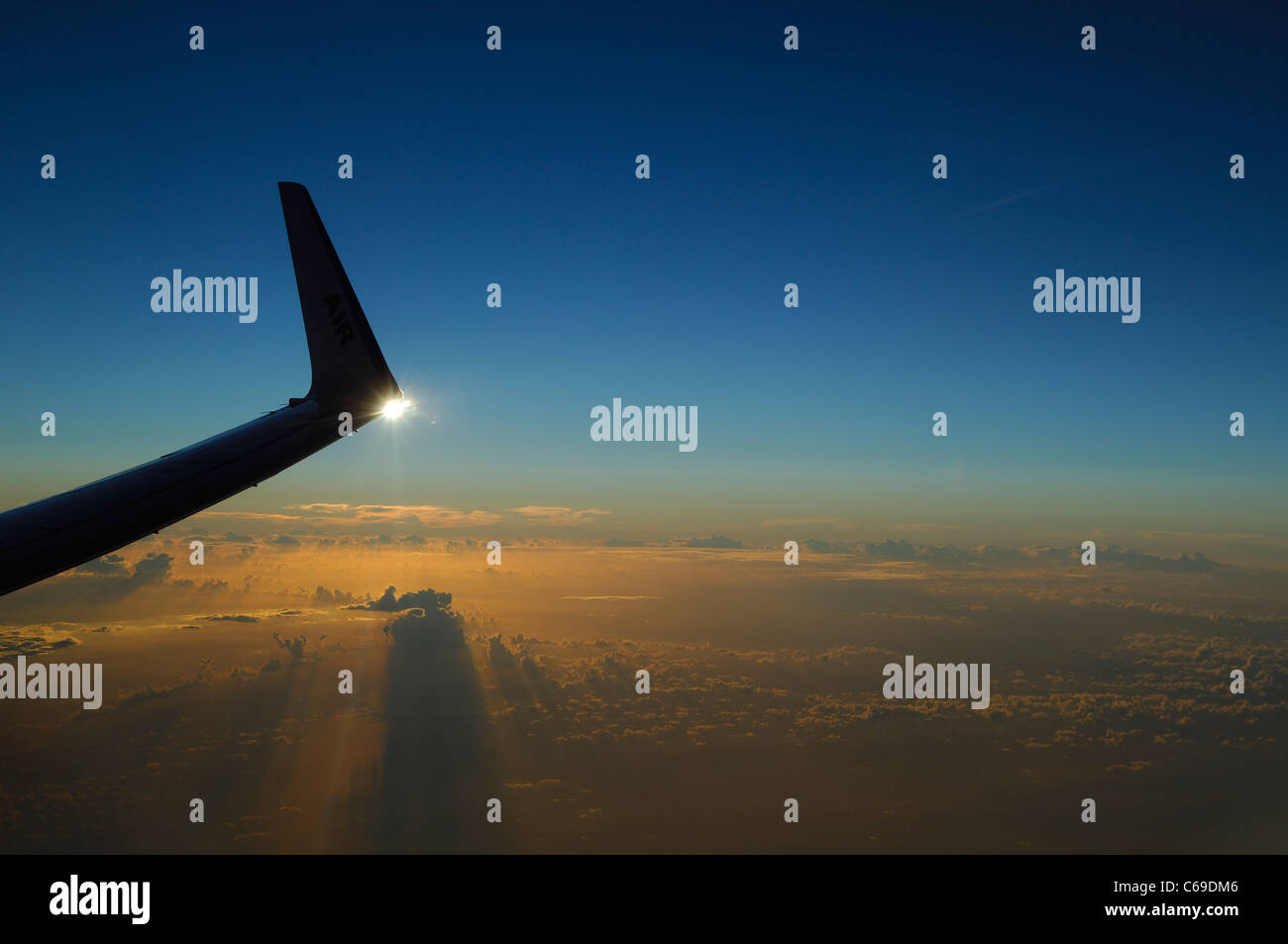 Wing tip of Boeing 737-800 airliner plane at sunset over Atlantic Ocean ...