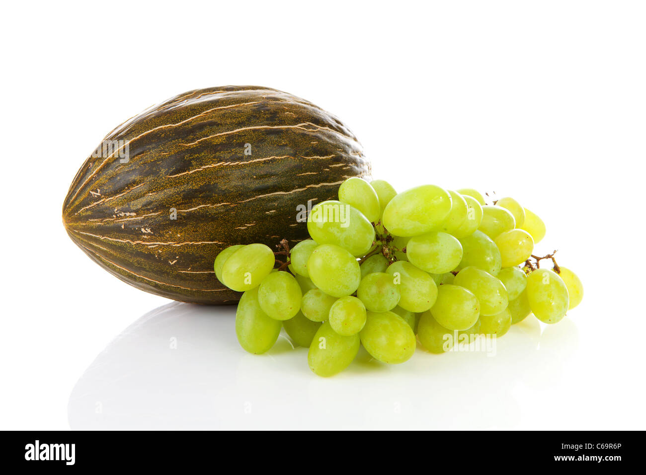Fresh melon and grapes over white background Stock Photo - Alamy