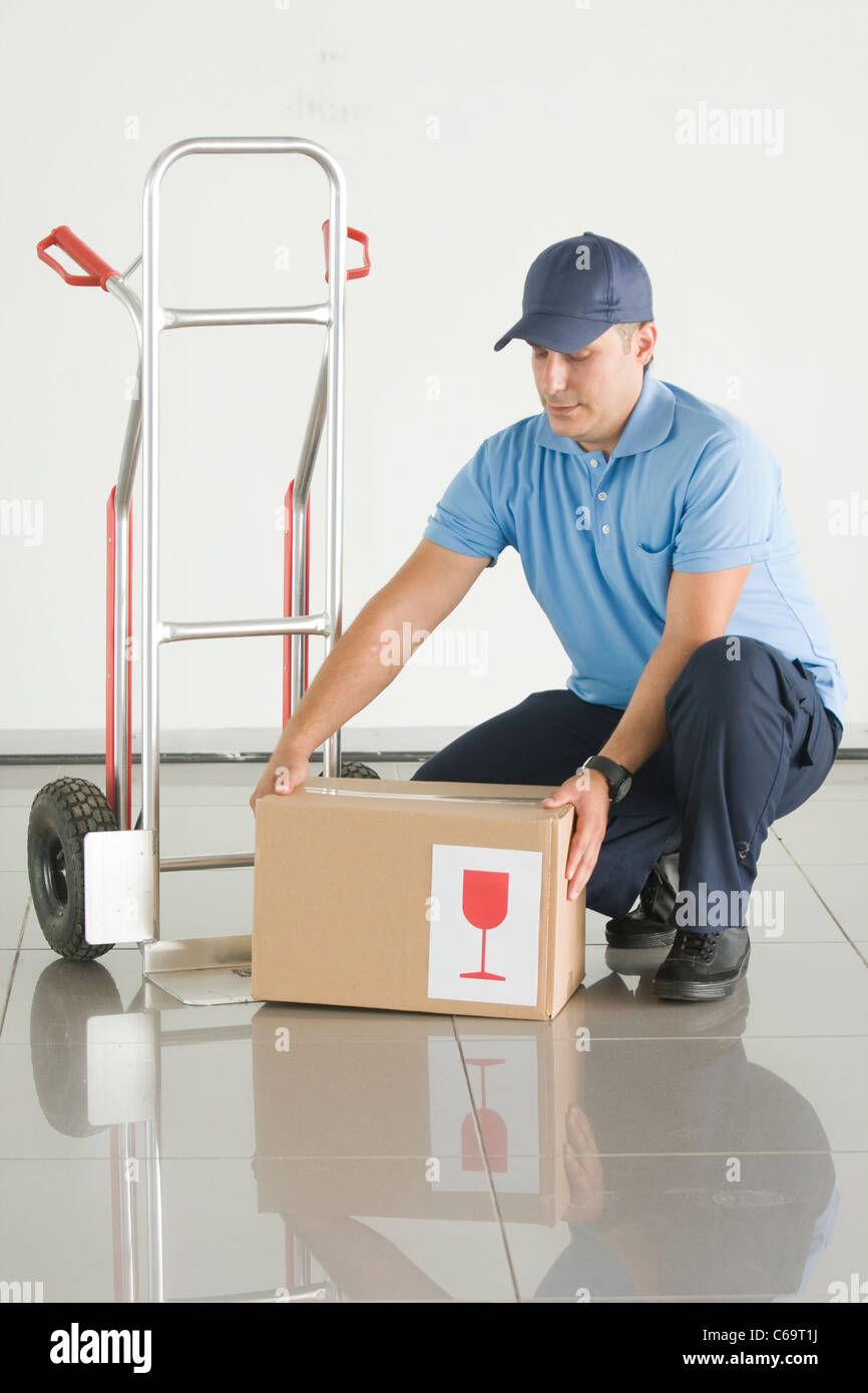 Side view of delivery man in uniform Stock Photo - Alamy