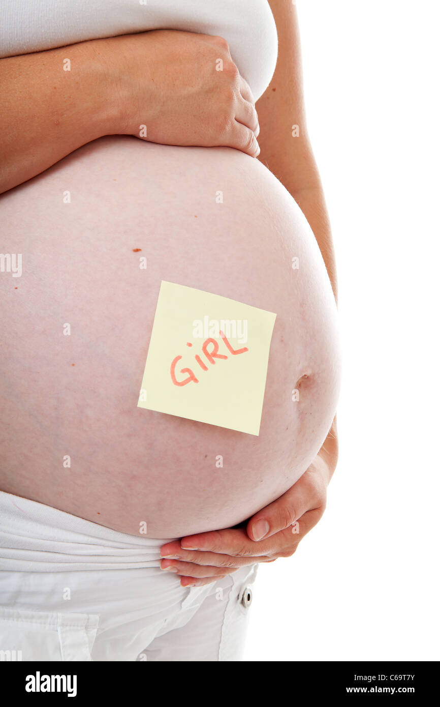 Pregnant belly with sticky note Girl over white background Stock Photo ...