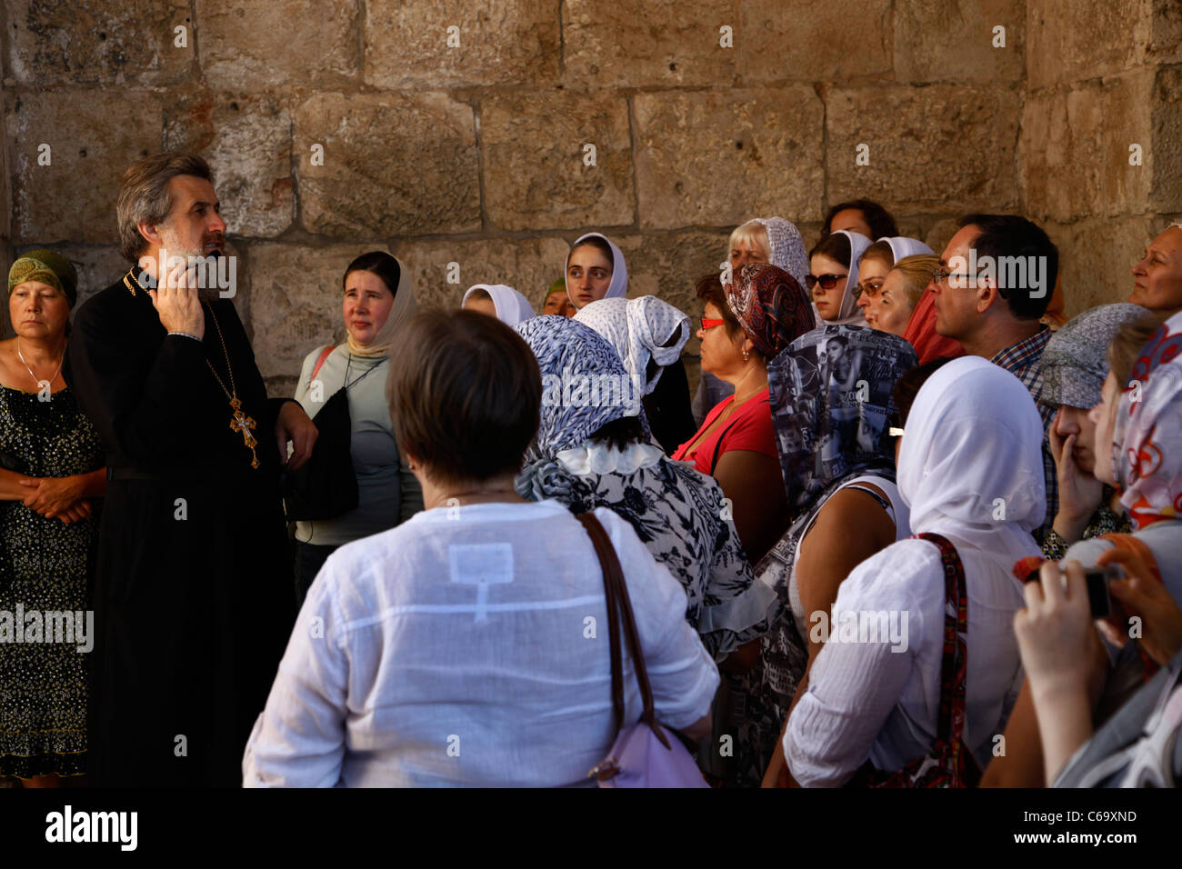 An Eastern Christian orthodox priest leads a group of Russian pilgrims ...
