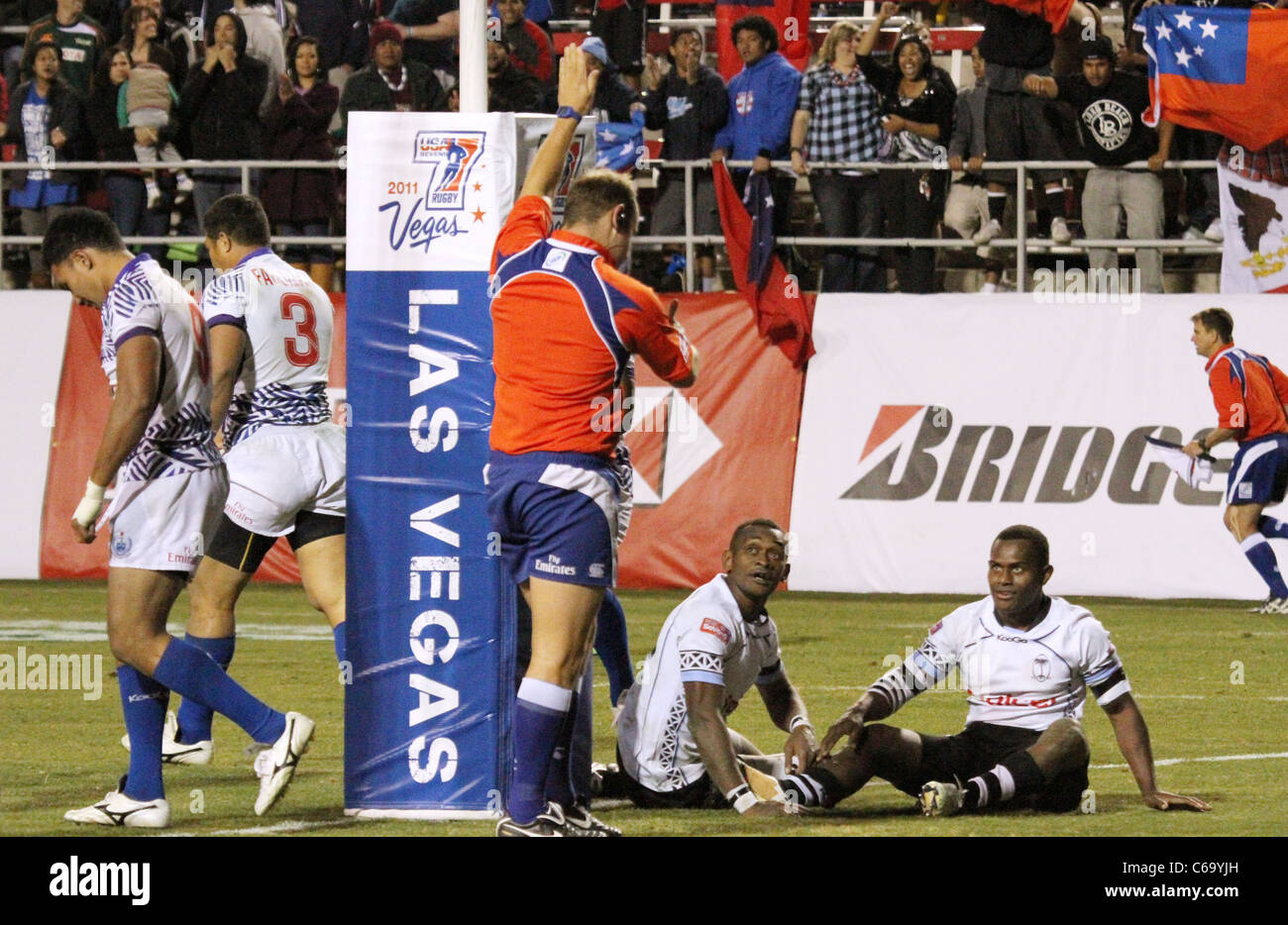 Referee Stuart Berry, Mitieli Nacagilevu, Emosi Vucago of Fiji at a ...