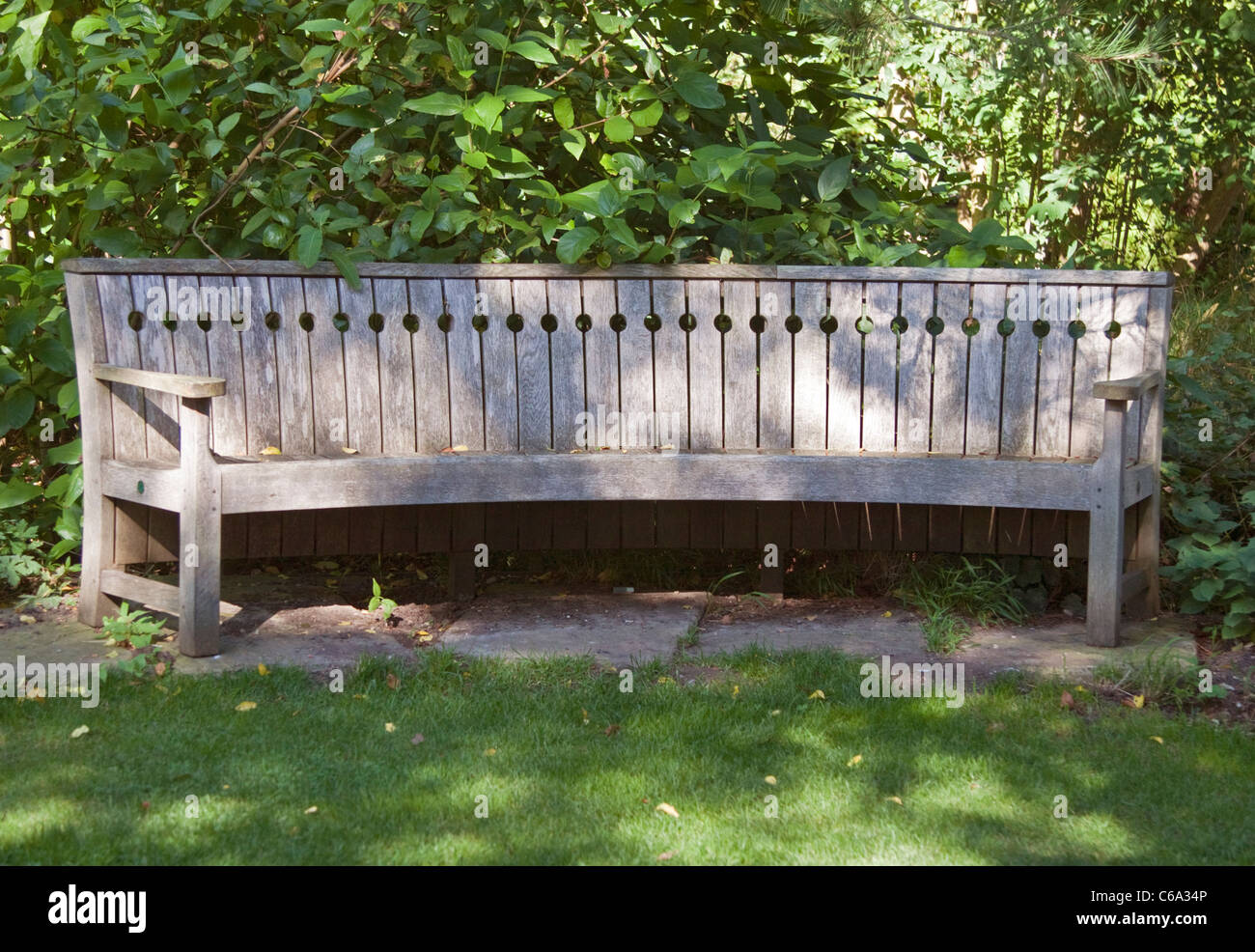 Curved Wooden Bench in Shady Garden Stock Photo - Alamy
