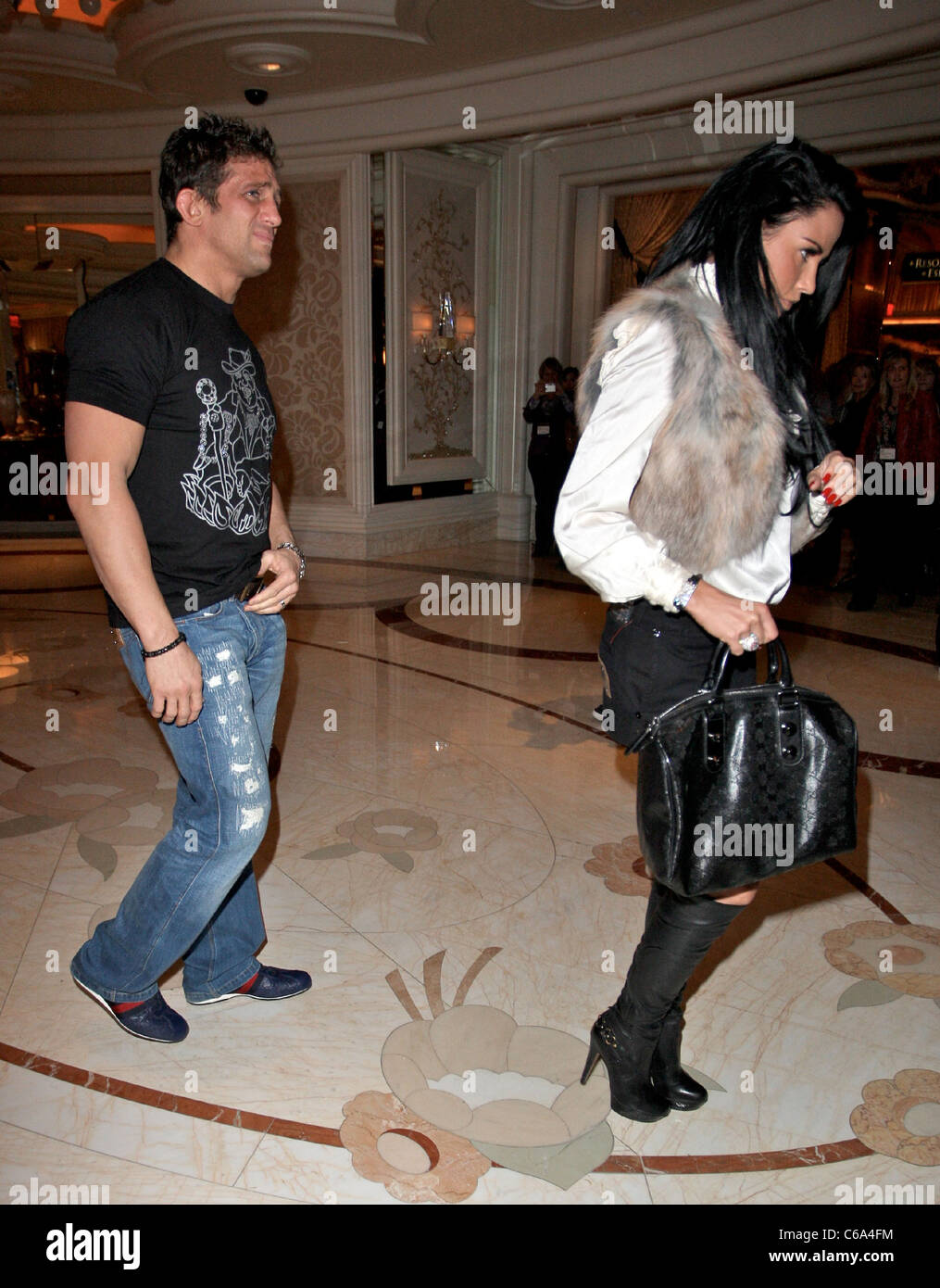 Katie Price arrives in the lobby of her hotel wearing a fur waistcoat ...