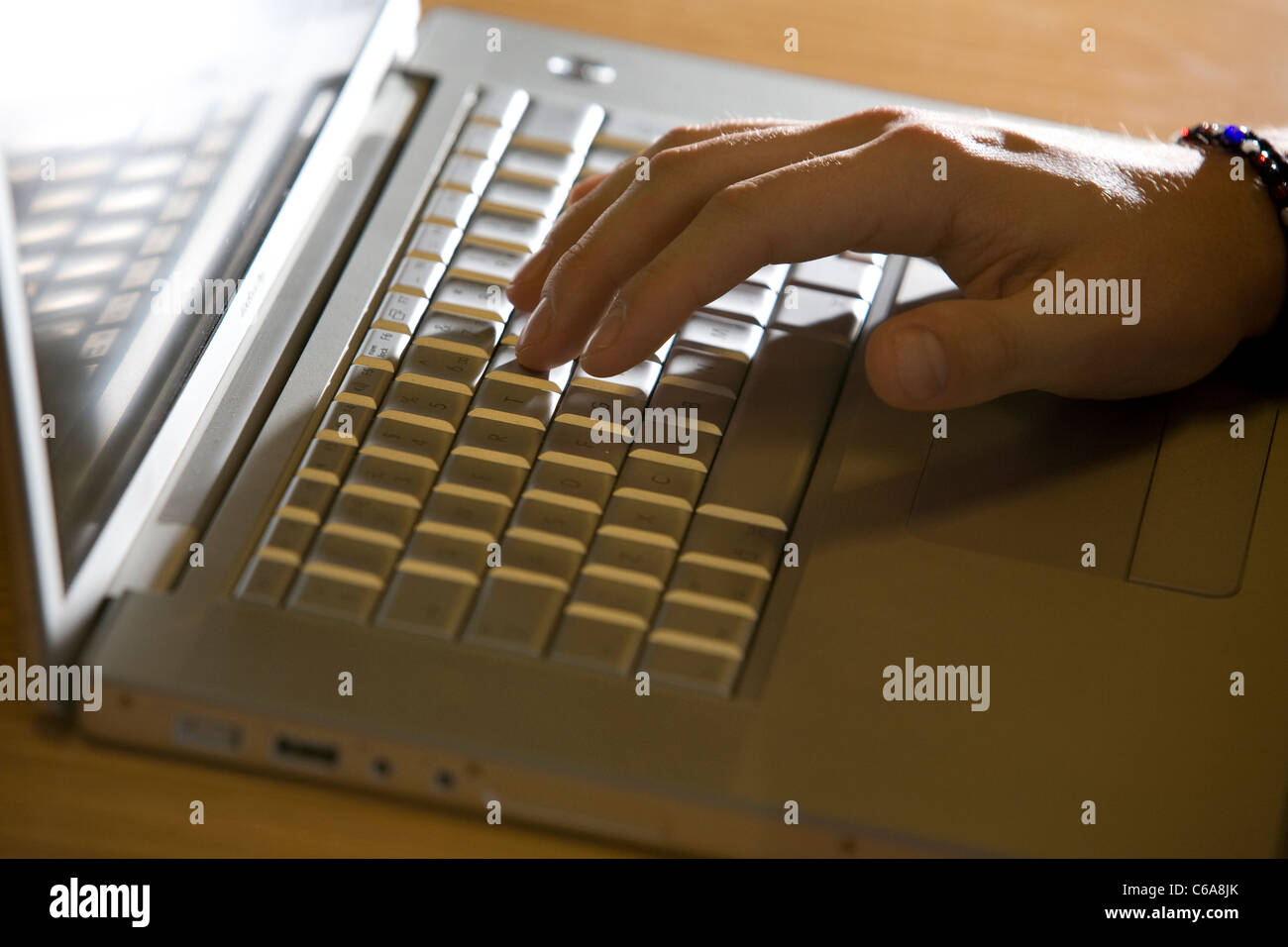 persons hand on laptop keyboard Stock Photo - Alamy