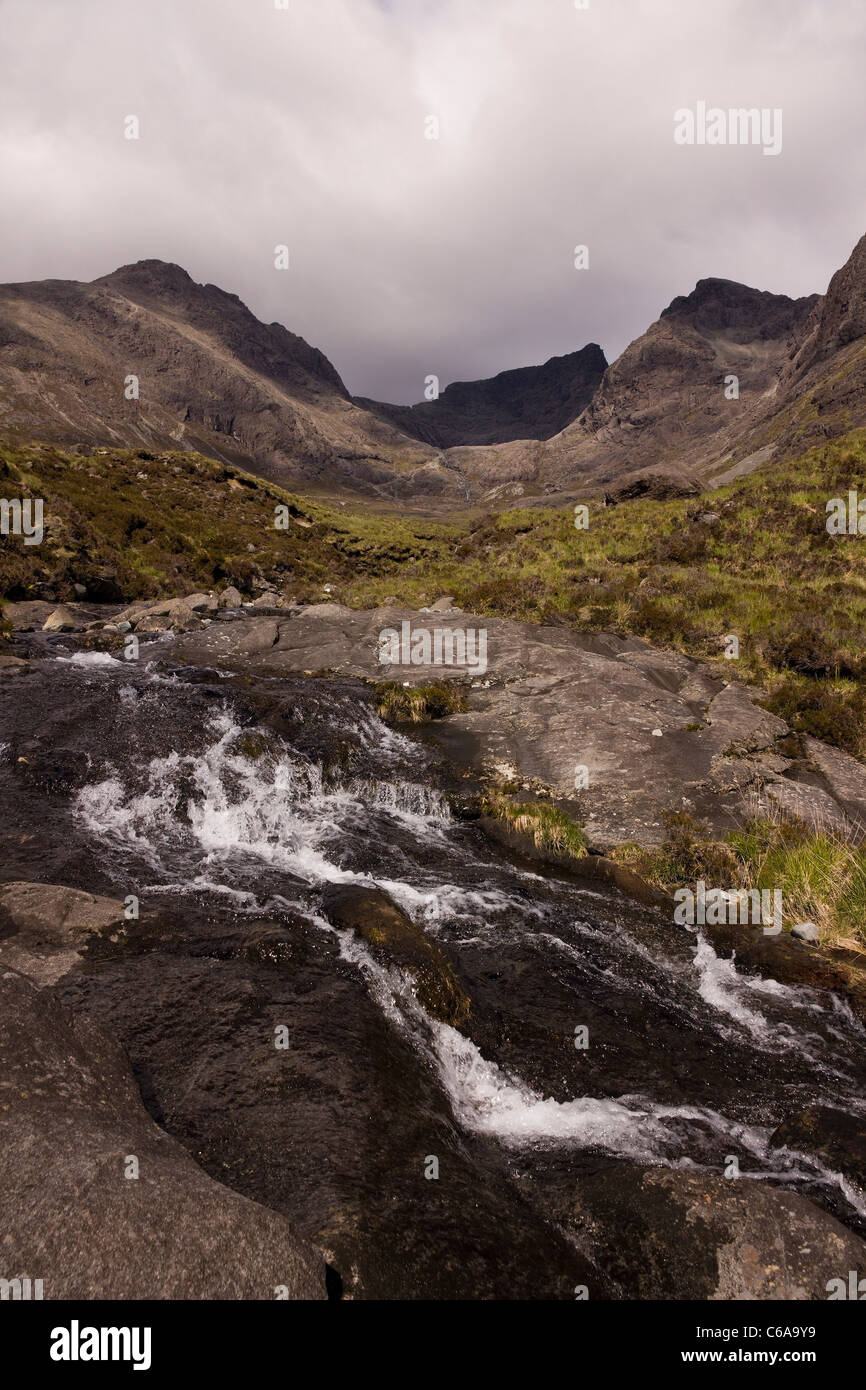 Tumbling mountain stream with the corrie of Coire Lagan in the Black ...