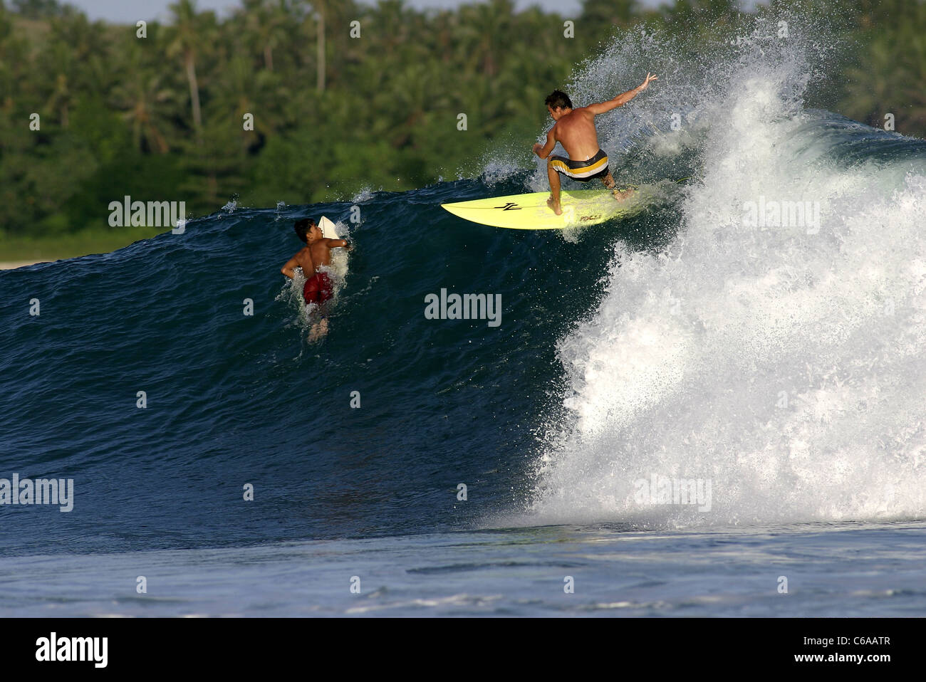 Surfer riding a large wave. Sorake Beach, Lagundri Bay, Nias, Sumatra ...