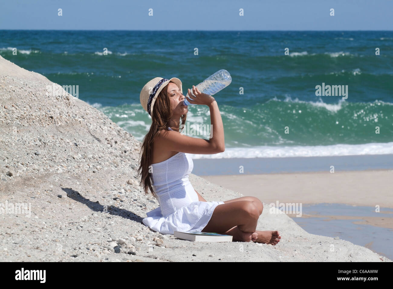 woman drinking on the beach Stock Photo - Alamy
