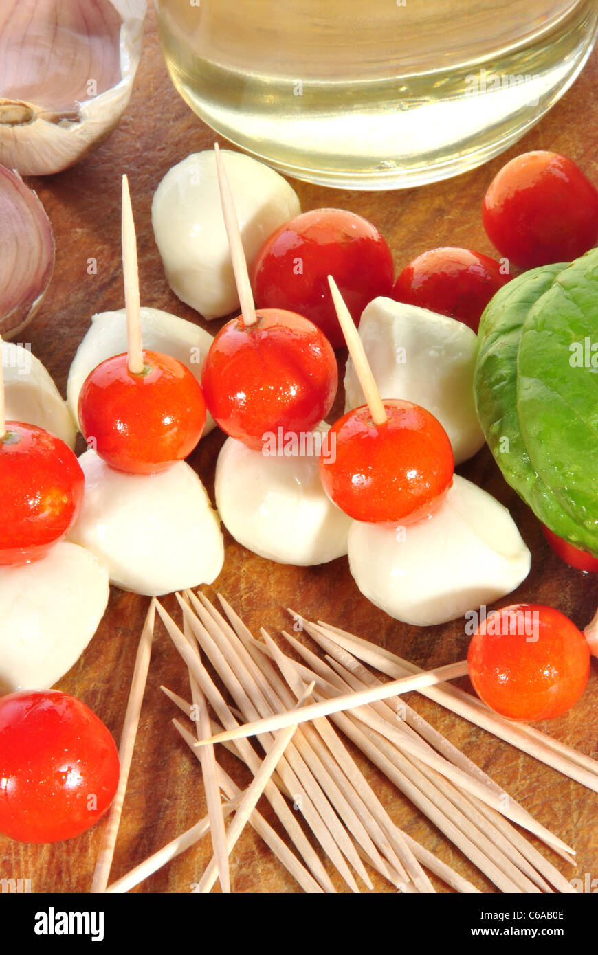 Snack with mozzarella and party tomato is prepared Stock Photo - Alamy
