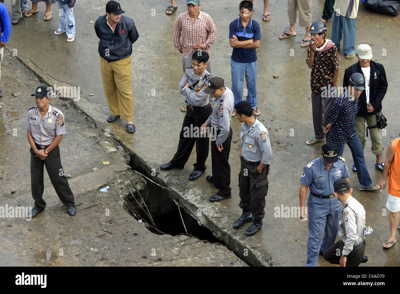 Police stop people from falling down hole in earthquake damaged wharf ...