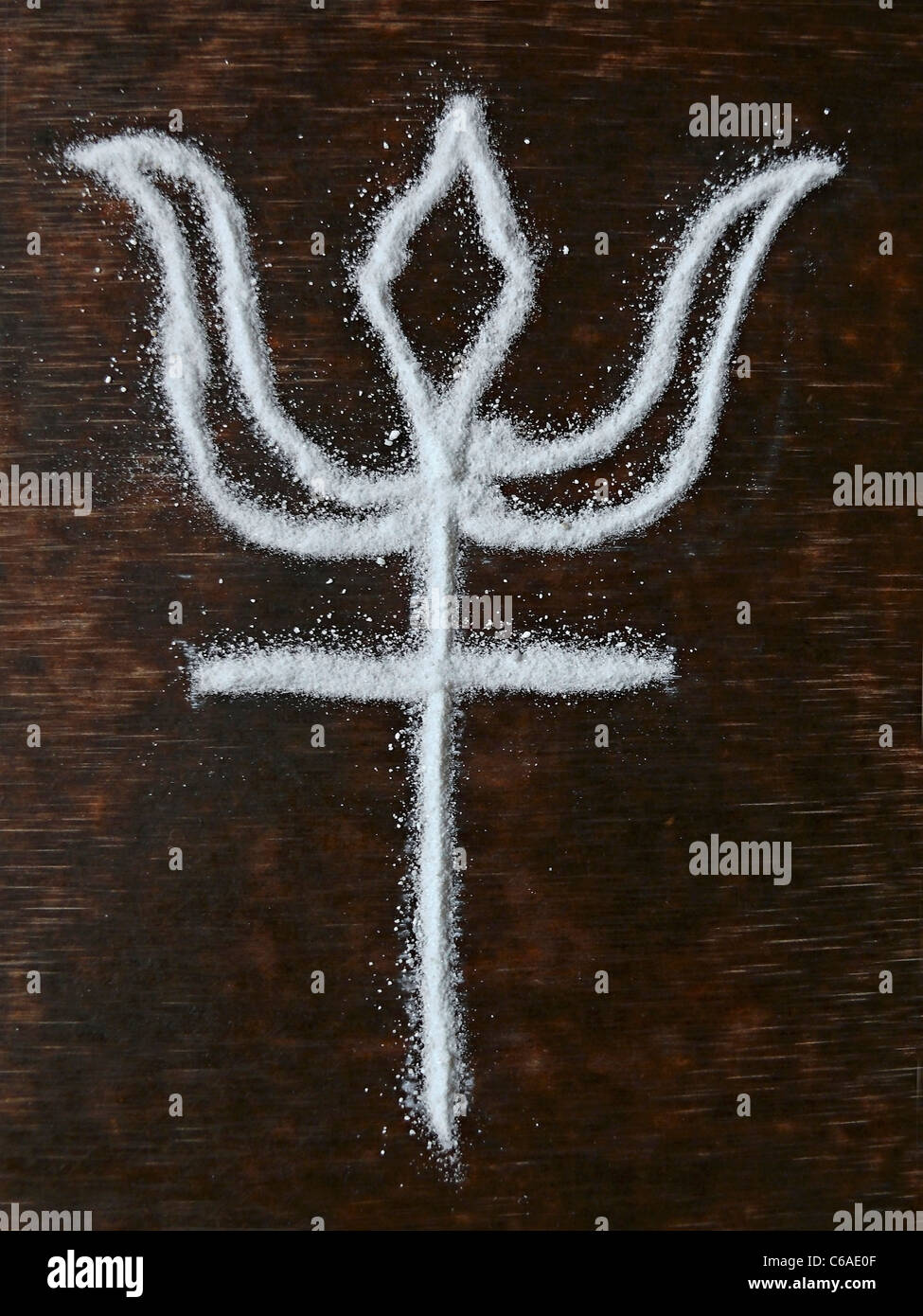 A holy sign called Trishul is made by white powder, called as Rangoli ...
