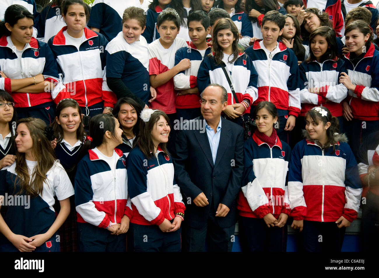 President Felipe Calderon poses with students at a school in Morelia ...