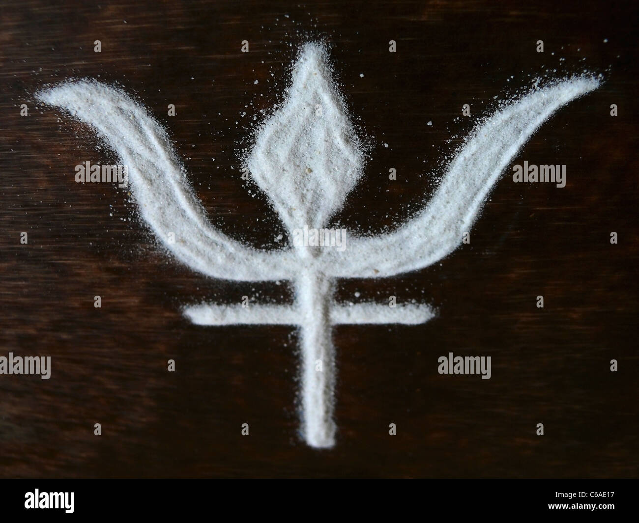 A holy sign called Trishul is made by white powder, called as Rangoli ...