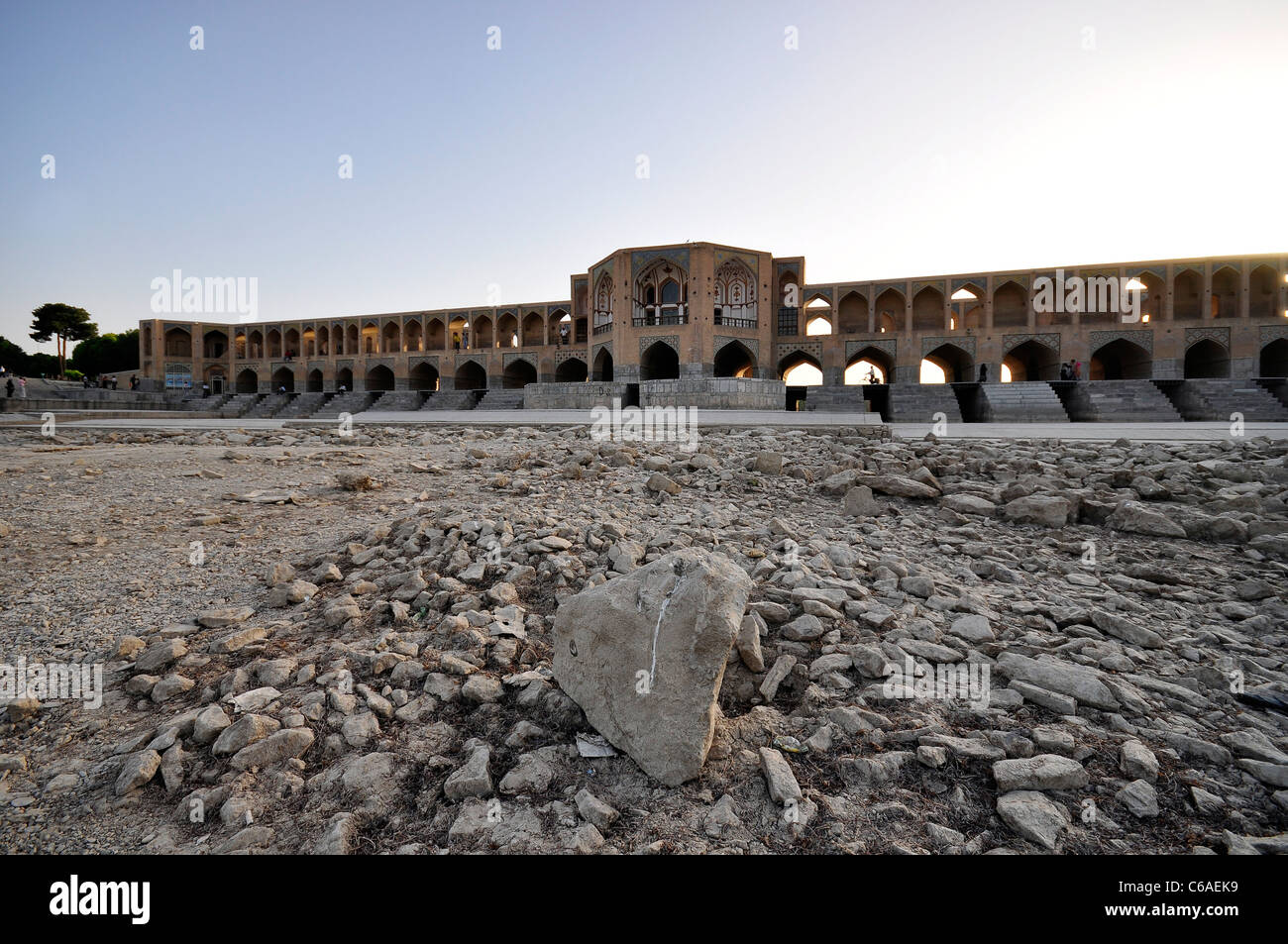 Dried riverbed of Zayandeh river with Khaju Bridge in background ...
