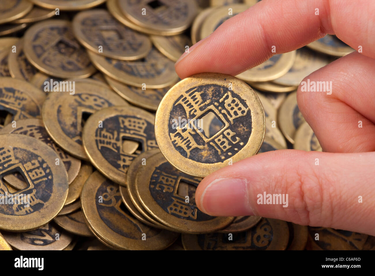 Hand holding traditional Chinese coin Stock Photo - Alamy