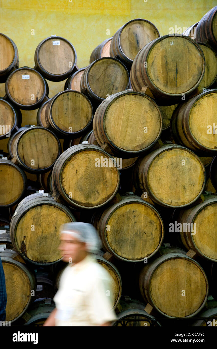 A worker walks past barrels of aging tequila at Jose Cuervo plant in ...