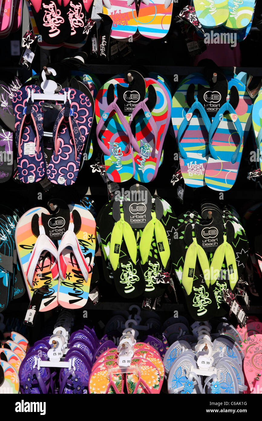 Multi-colored flip-flops for sale at a holiday store Stock Photo - Alamy