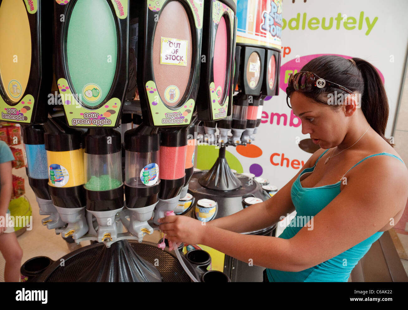 A teenage girl buying sweets in the Candylicious store, Sentosa Island ...