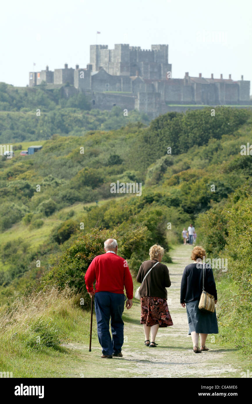 Senior citizens walk along the white cliffs of Dover coastal path, with ...