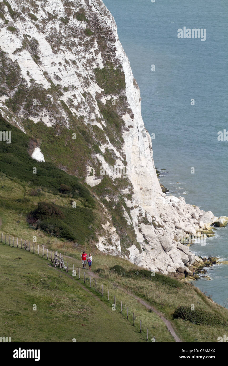 Walkers trekking along the white cliffs of Dover coastal path. Kent ...