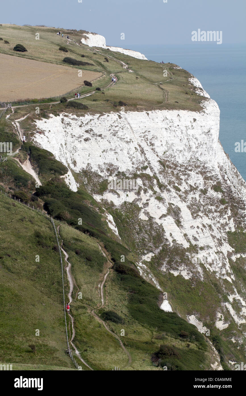 Walkers trekking along the white cliffs of Dover coastal path. Kent ...