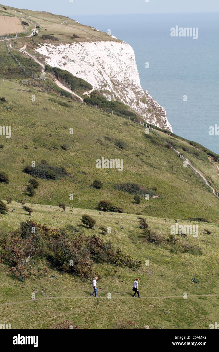 Walkers trekking along the white cliffs of Dover coastal path. Kent ...