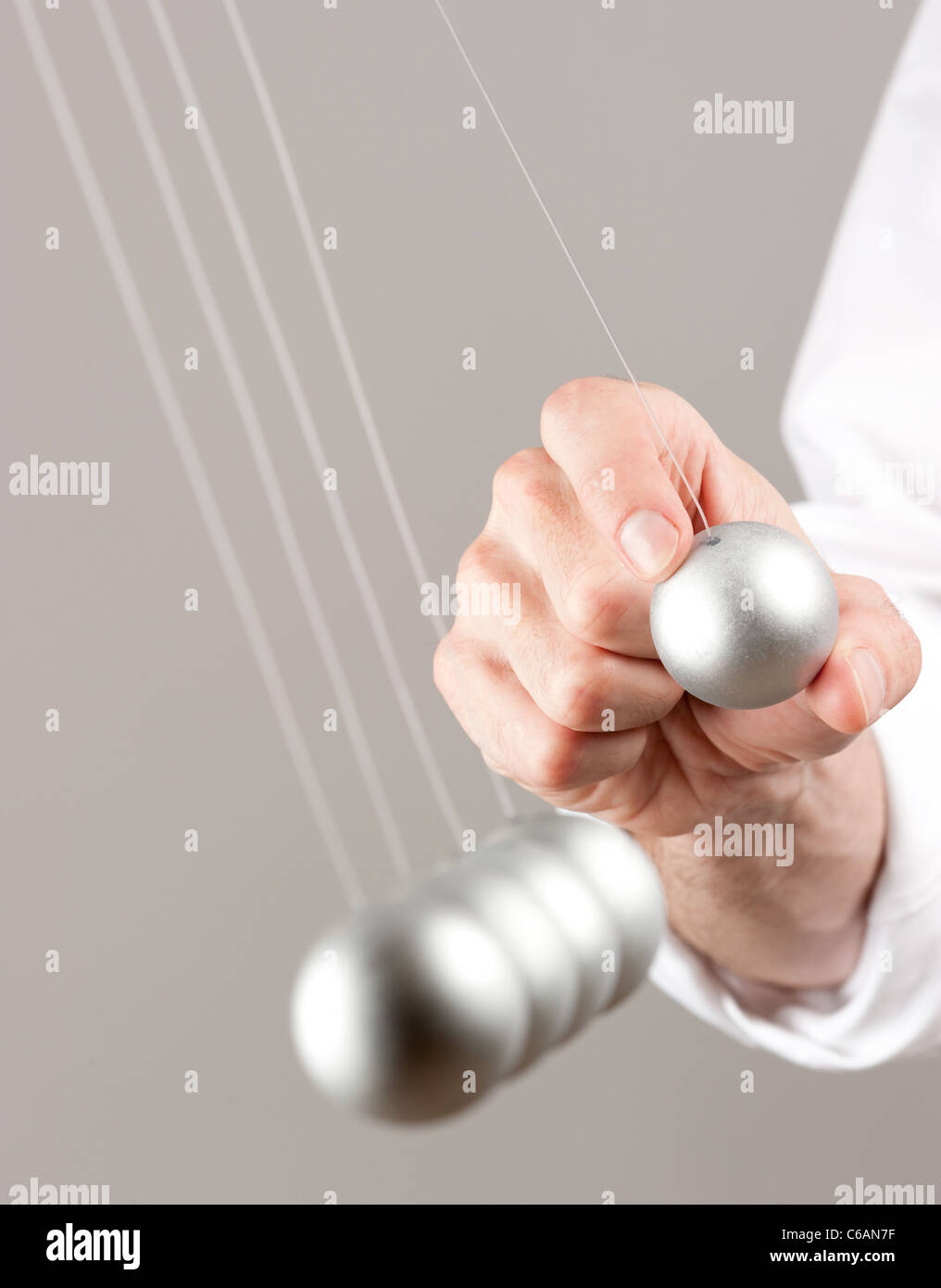 Hand holding pendulum ball hi-res stock photography and images - Alamy
