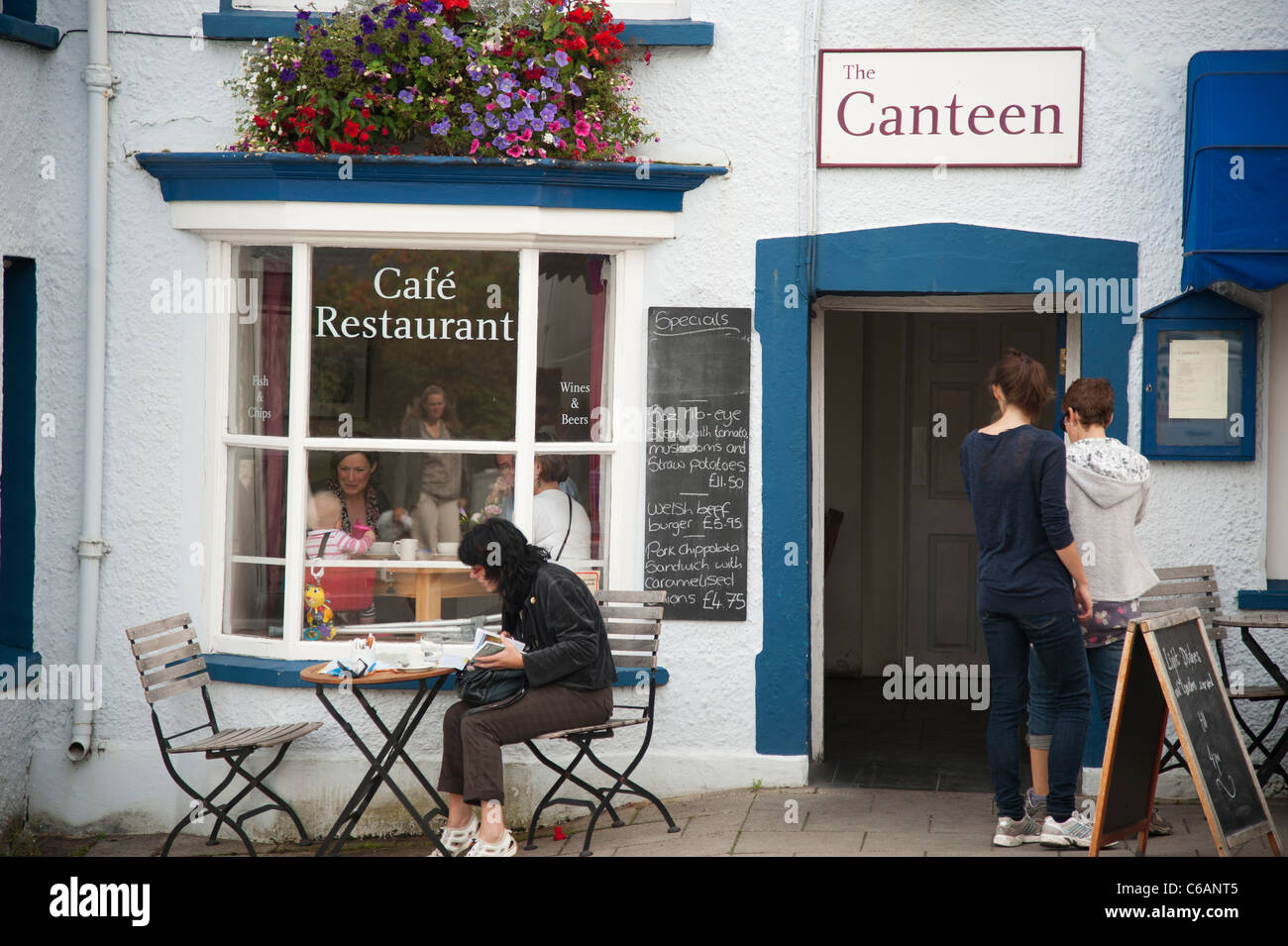 People eating breakfast at an outdoor cafe, Newport, Pembrokeshire ...