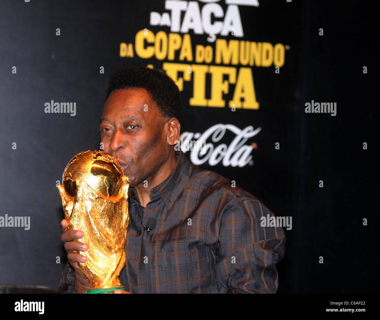 Former football star Pele holds up the FIFA World Cup trophy. The ...